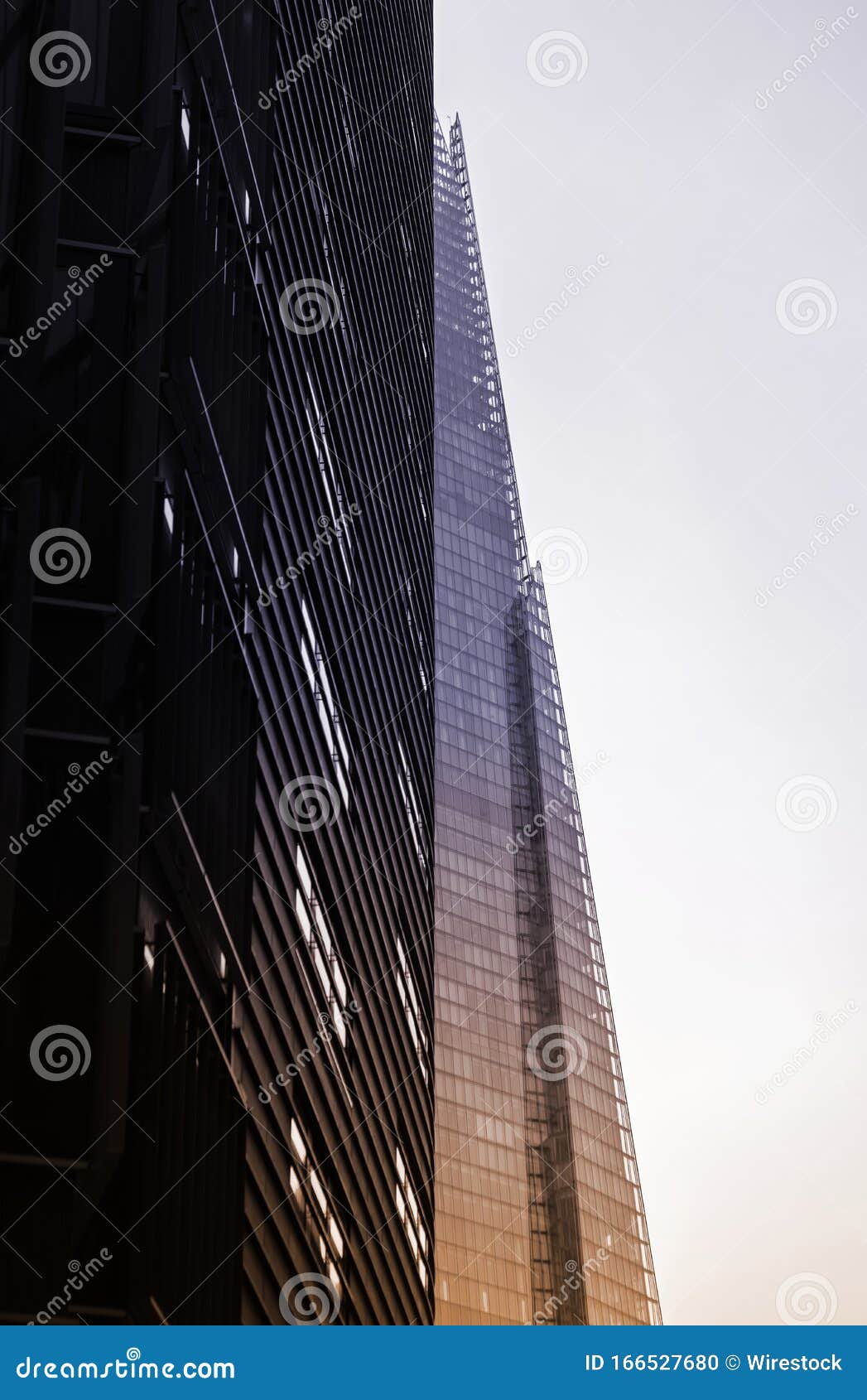 Vertical Low Angle Shot of a High Rise Building in a Glass Facade Under ...