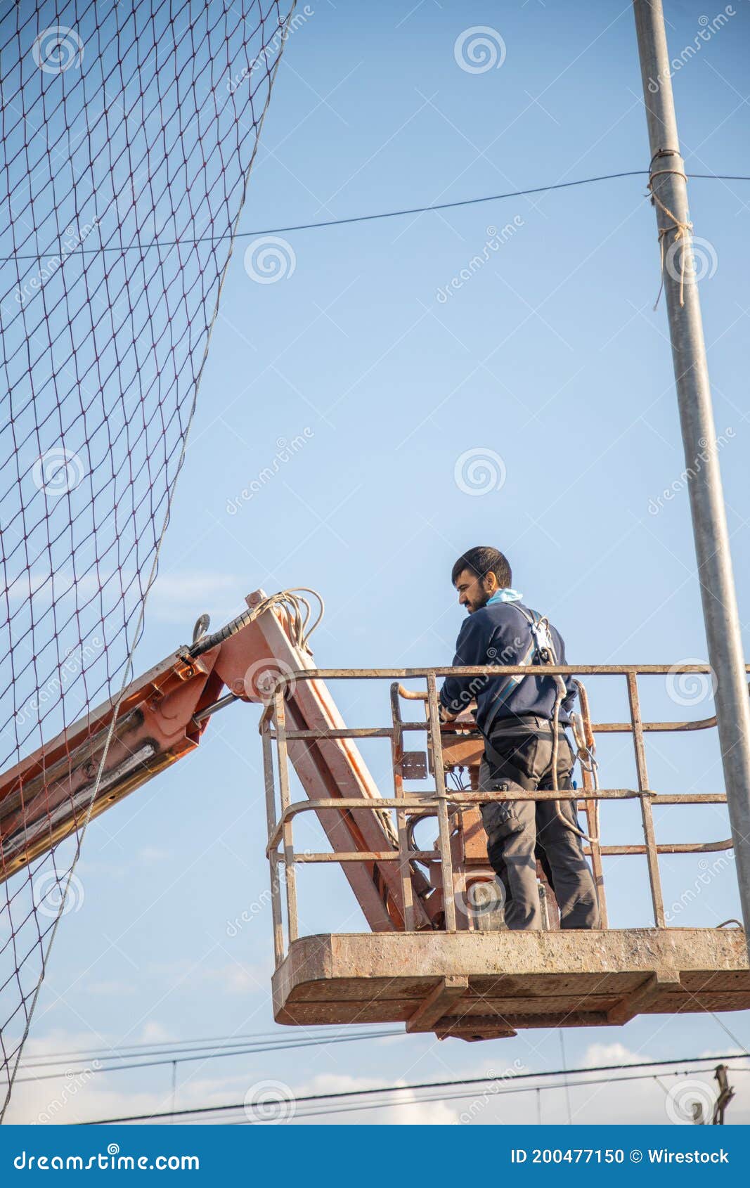 Vertical Low Angle Shot of a Man Working at a Construction Site ...