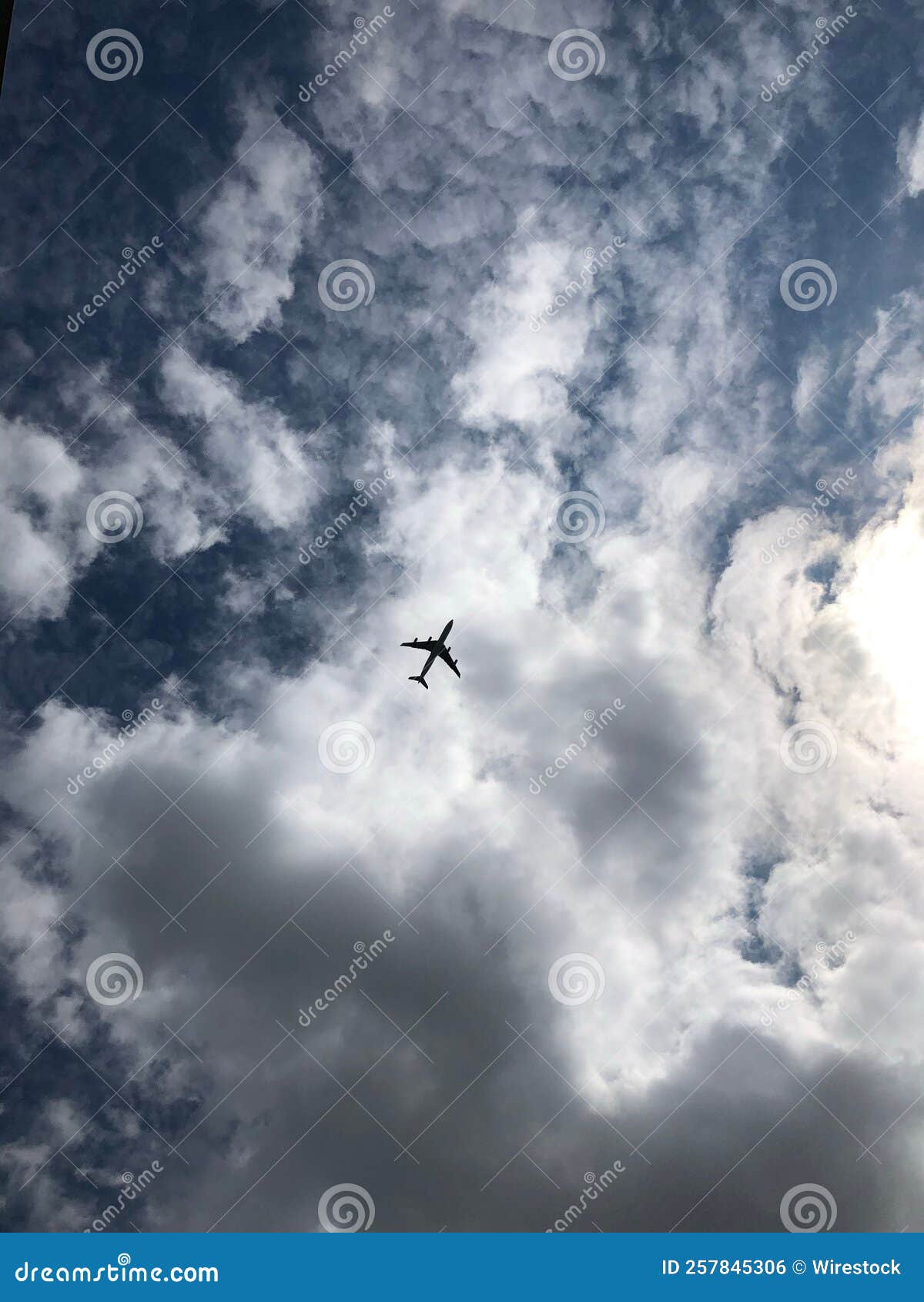 Vertical Low Angle Shot of a Plane in the Clouds Stock Photo - Image of ...