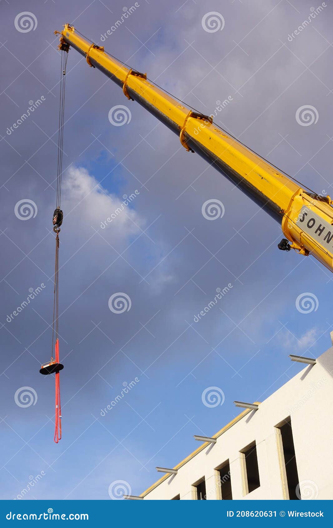 Vertical Low Angle Shot of a Tall Mobile Crane on a Construction Site ...
