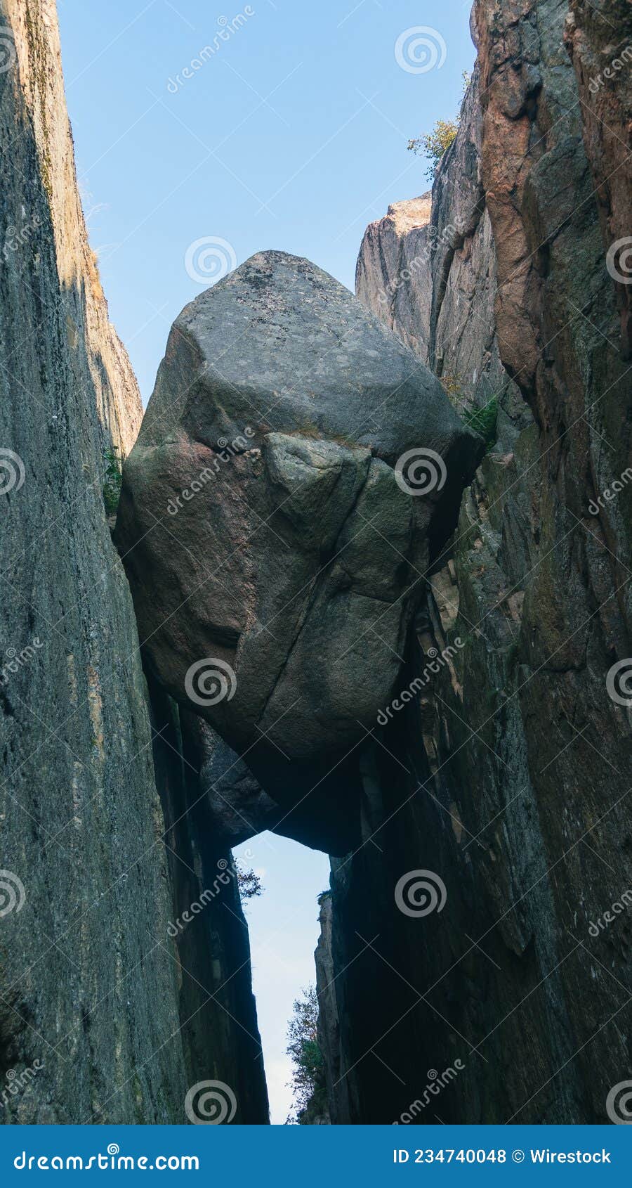 Vertical Low Angle View of a Big Stone Stuck in between Two Cliffs ...