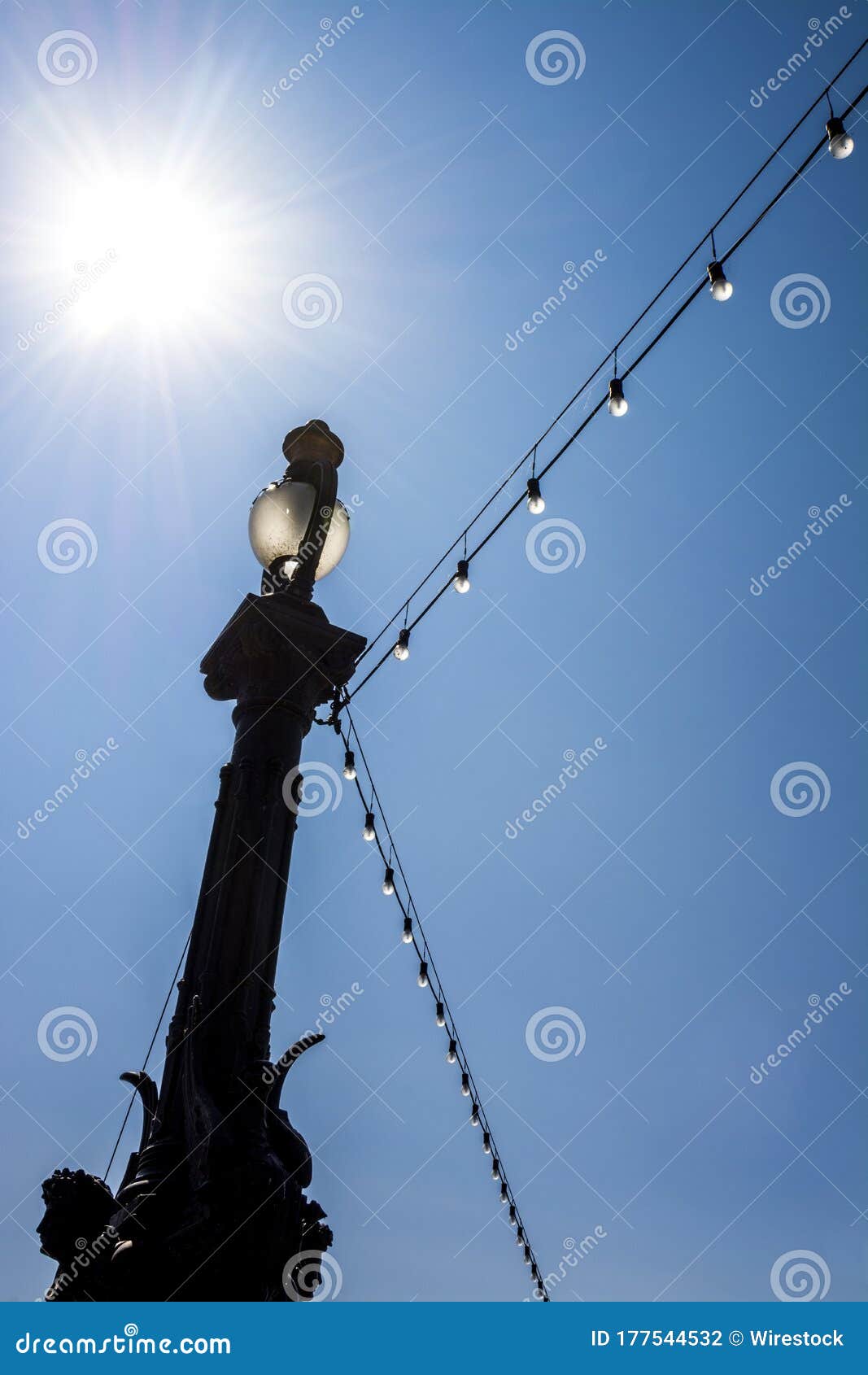 Vertical Low Angle View of a Street Lamp Under the Sunlight and a Blue ...