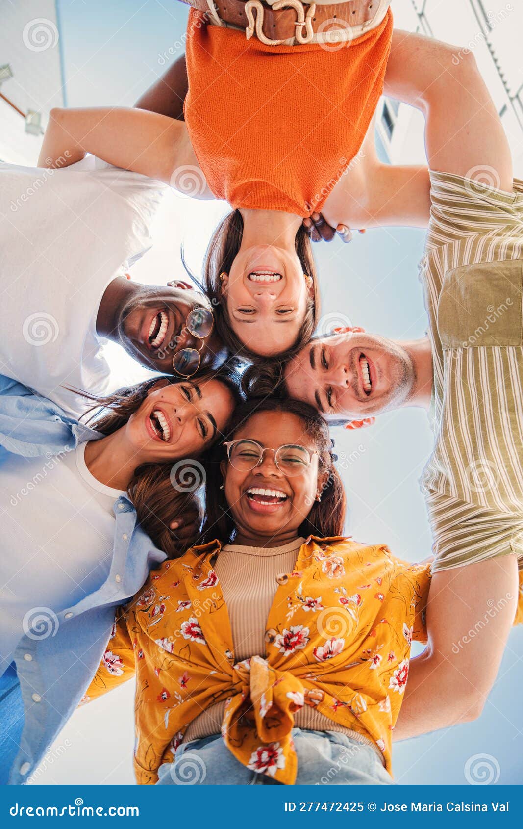 Vertical Low View Angle of a Group of Multiracial Teenagers Smiling and ...