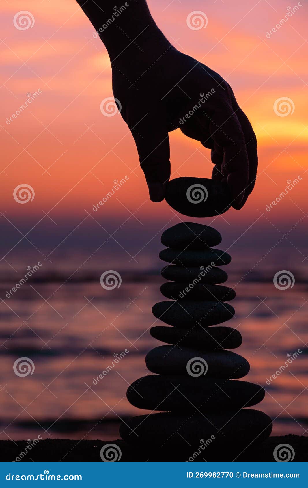 Vertical ?mage of Stacking Rocks on the Beach with a Sunset Ocean Stock ...