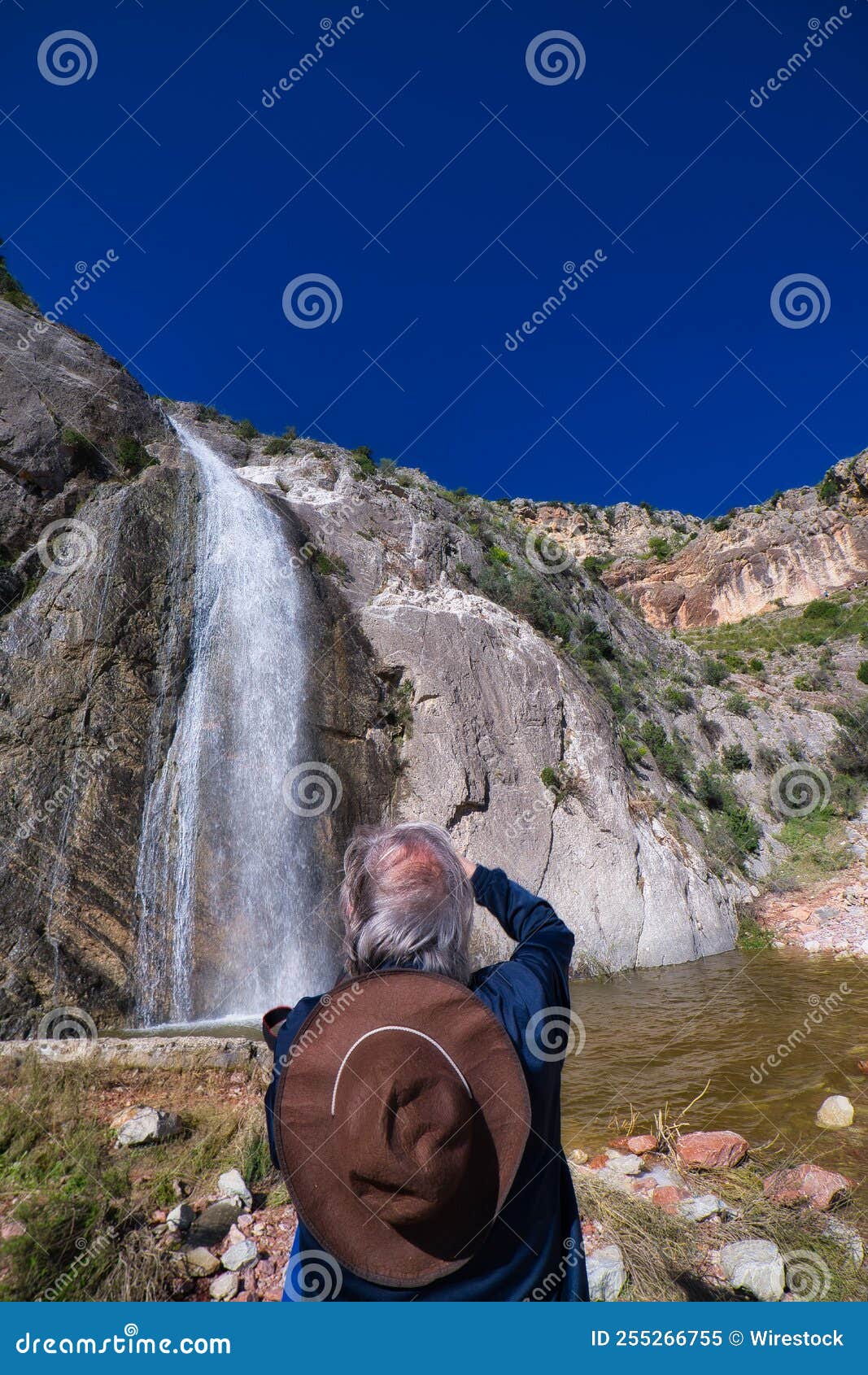 Vertical of an Old Man from Behind Who is Capturing the View of the ...