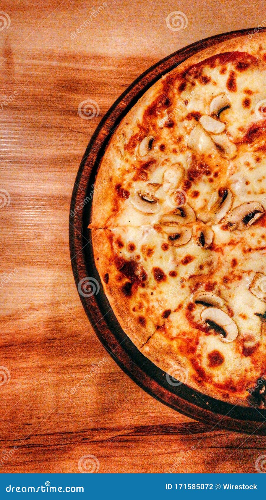 Vertical Overhead Shot of a Pizza Placed on a Wooden Surface Stock ...