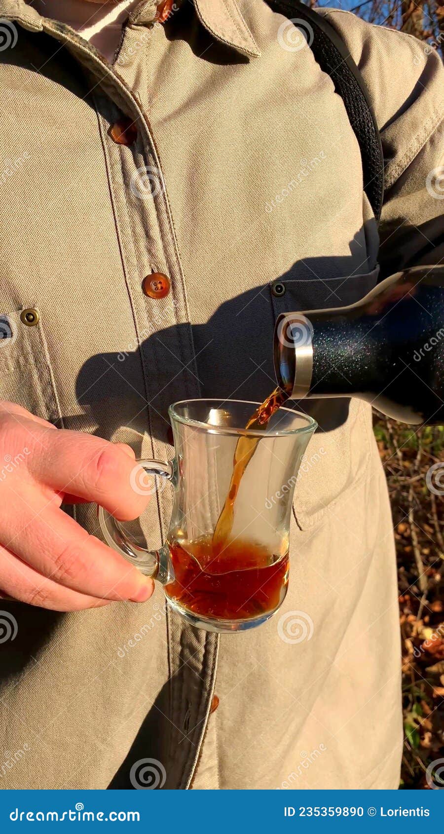 A Vertical Photo of a Man Who is Using a Thermos Stock Photo - Image of ...