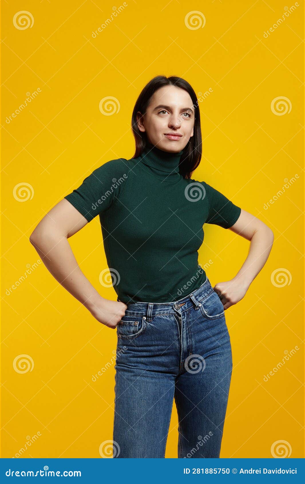 Young Confident Girl Wearing Green T Shirt And Jeans Holding Fists On