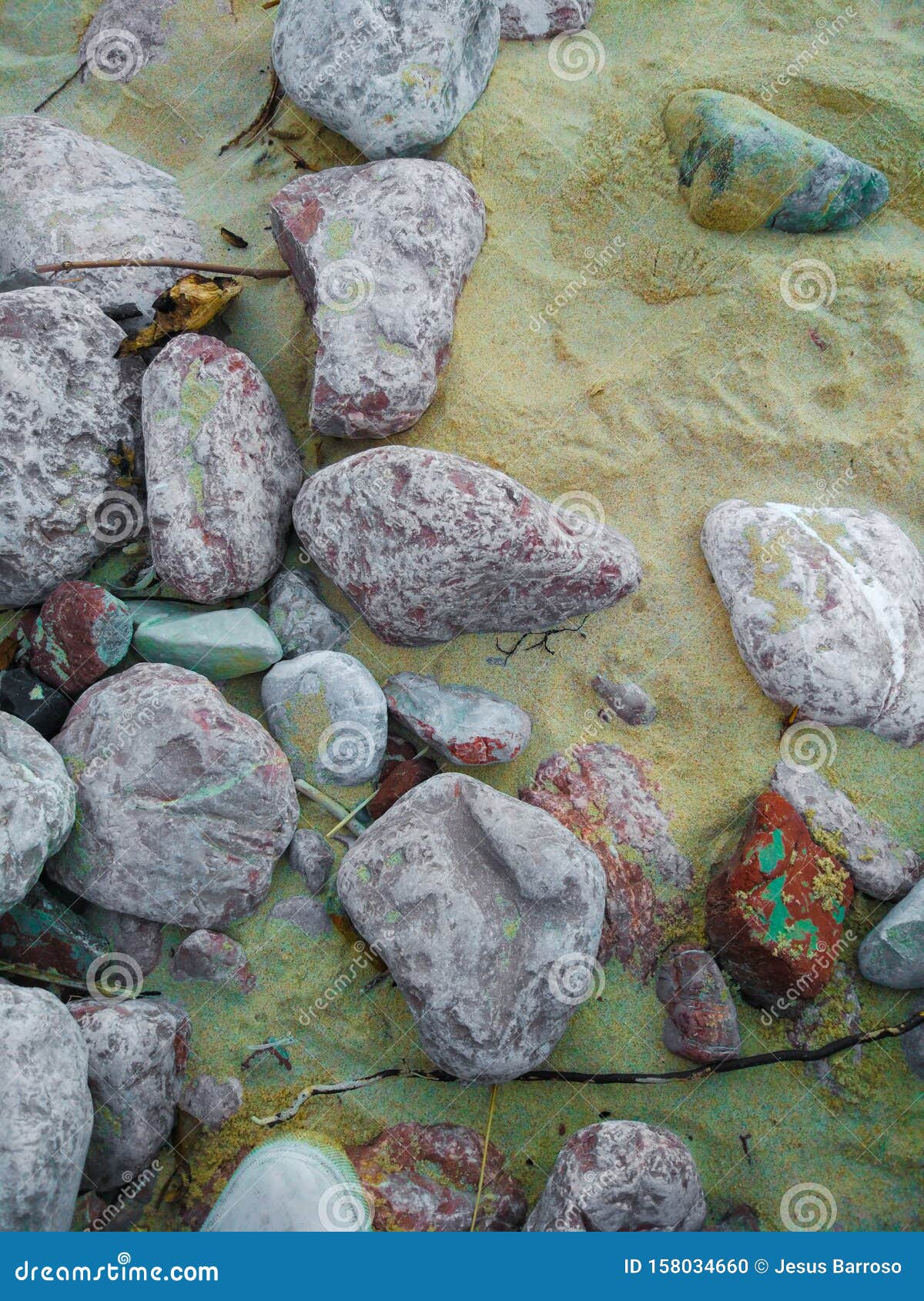 Vertical Picture of a Lot of Rocks of Different Colors on the Sand in a ...