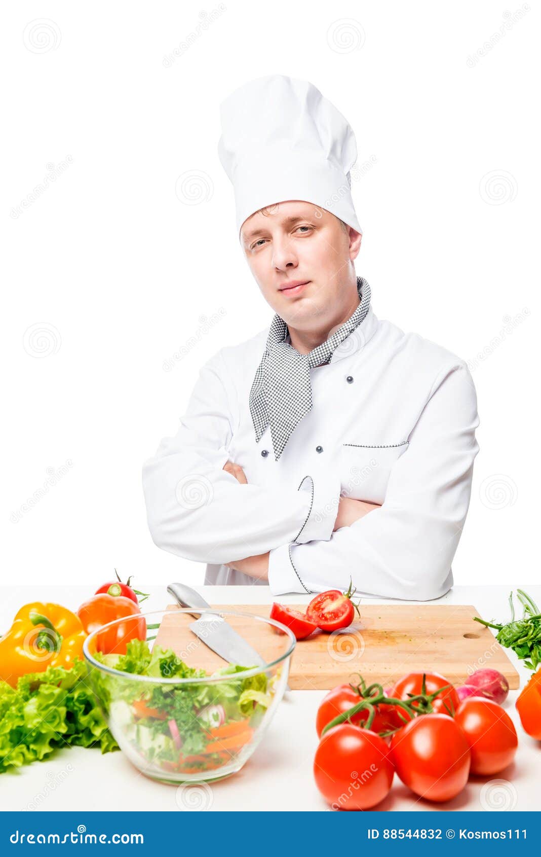 Vertical Portrait of a Cook at the Table with Vegetables on a White ...