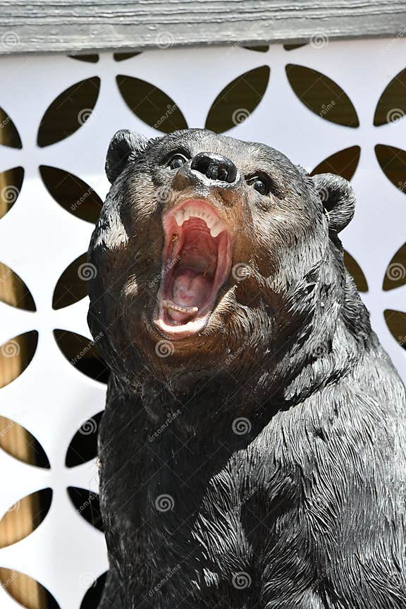 Vertical Portrait of a Grizzly Bear Statue before the White Patterned ...