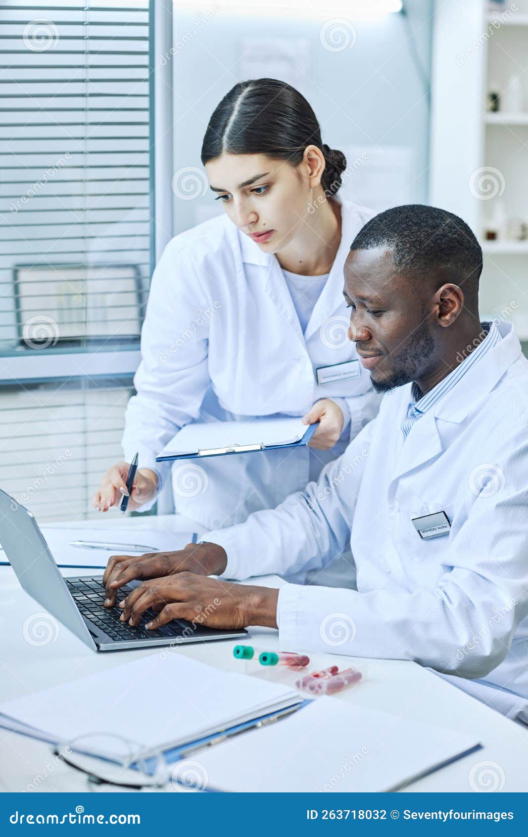 Two Scientists Using Laptop in Laboratory Stock Photo - Image of black ...