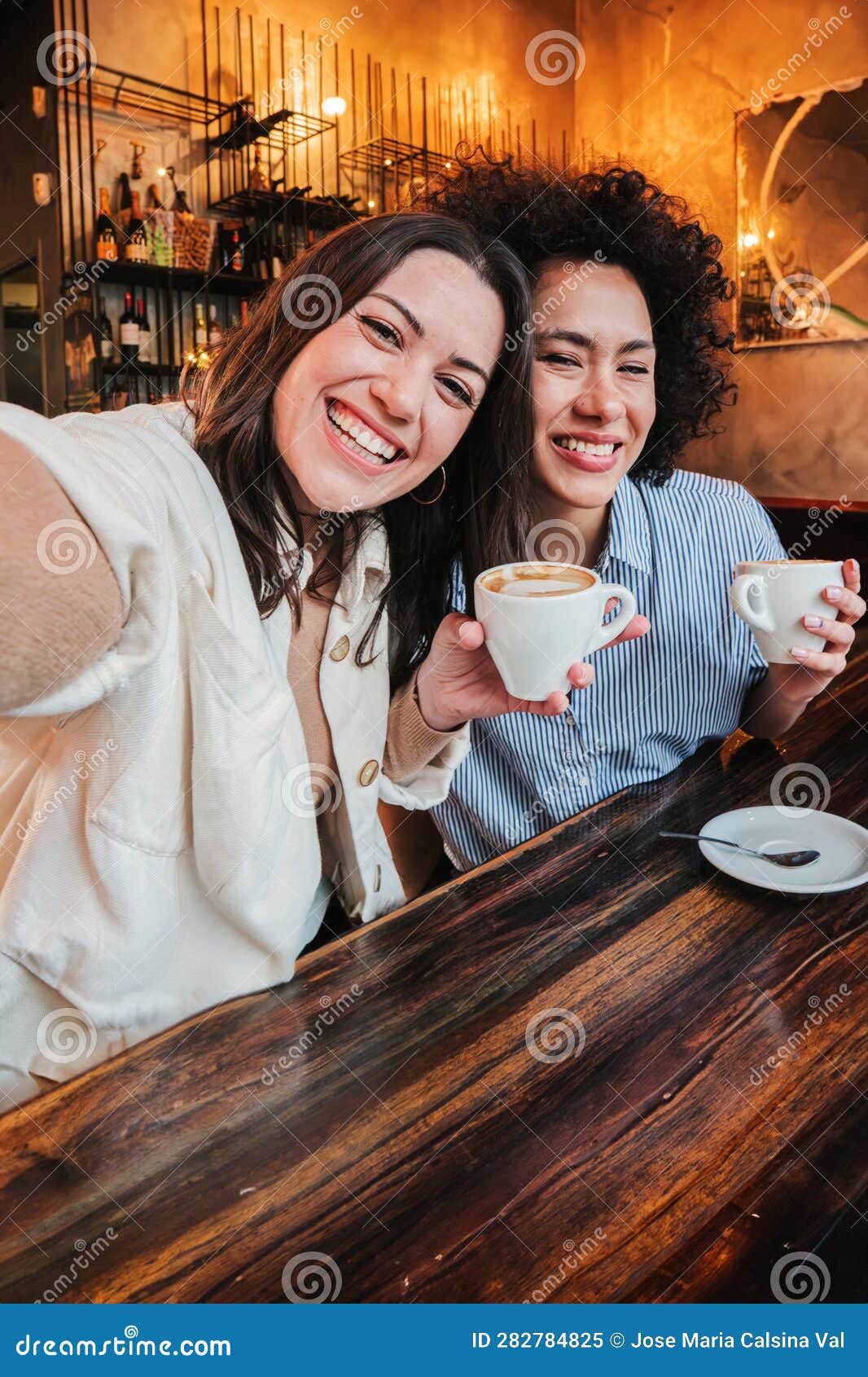 Vertical Portrait Of Two Young Adult Women Having Fun Taking A Selfie