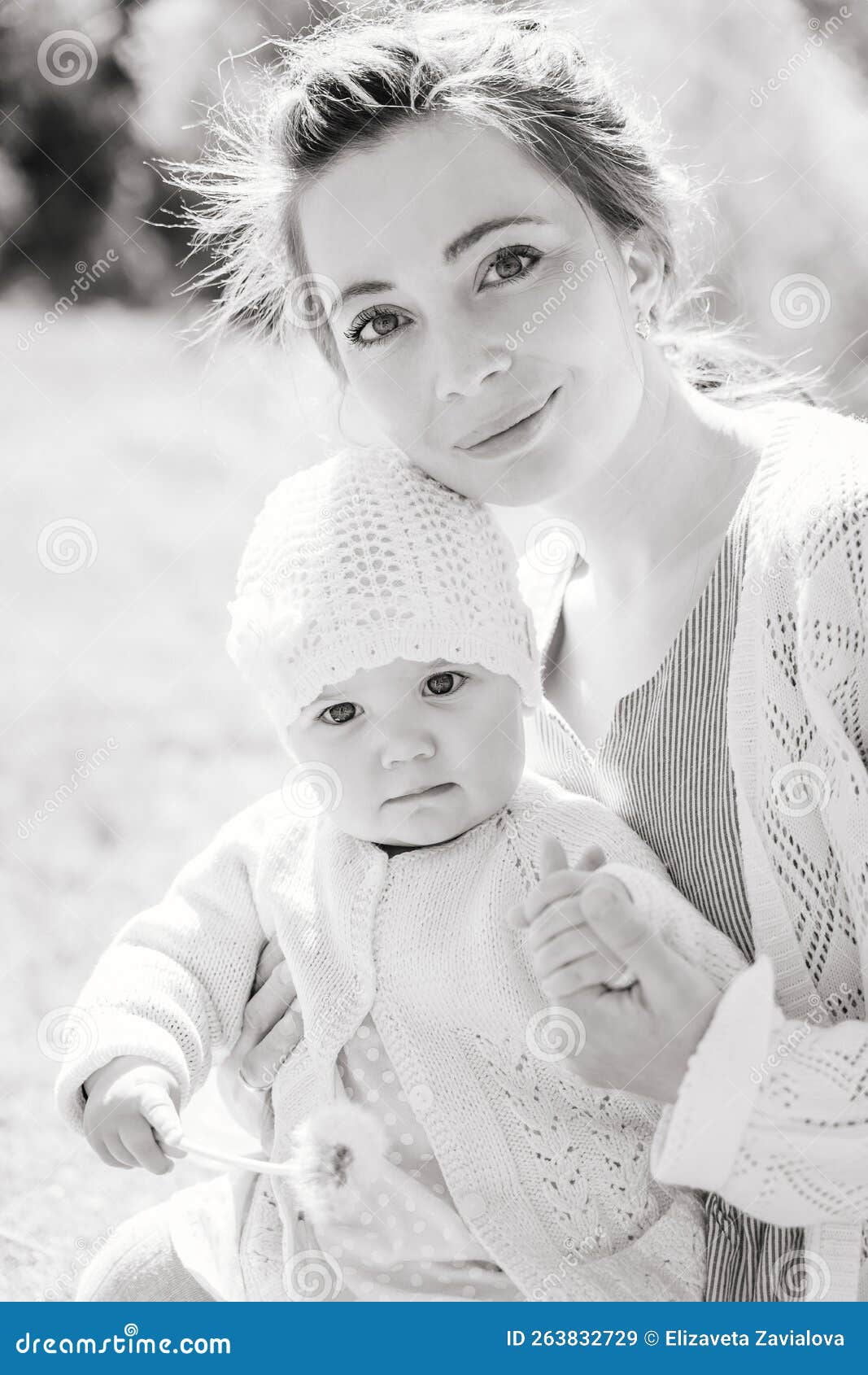 Vertical Portrait Of A Young Mother With A One Year Old Daughter In