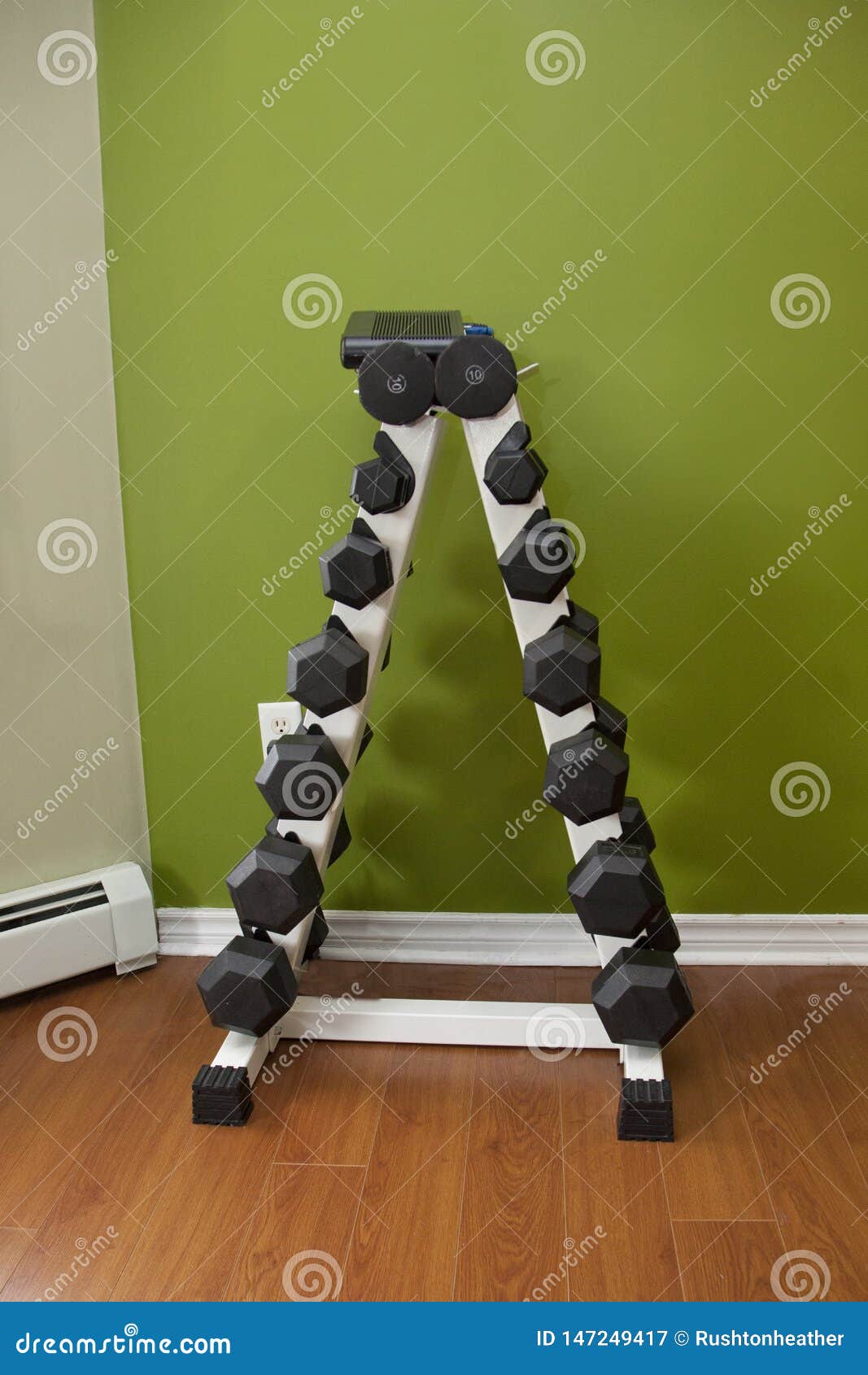 Vertical rack of dumbells stock image. Image of home - 147249417