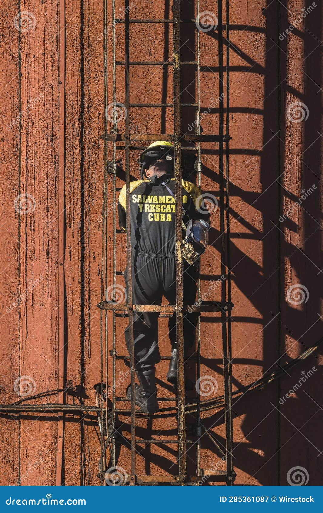 Vertical Rear View of a Cuban Firefighter Going Up a Fire Escape Stock ...