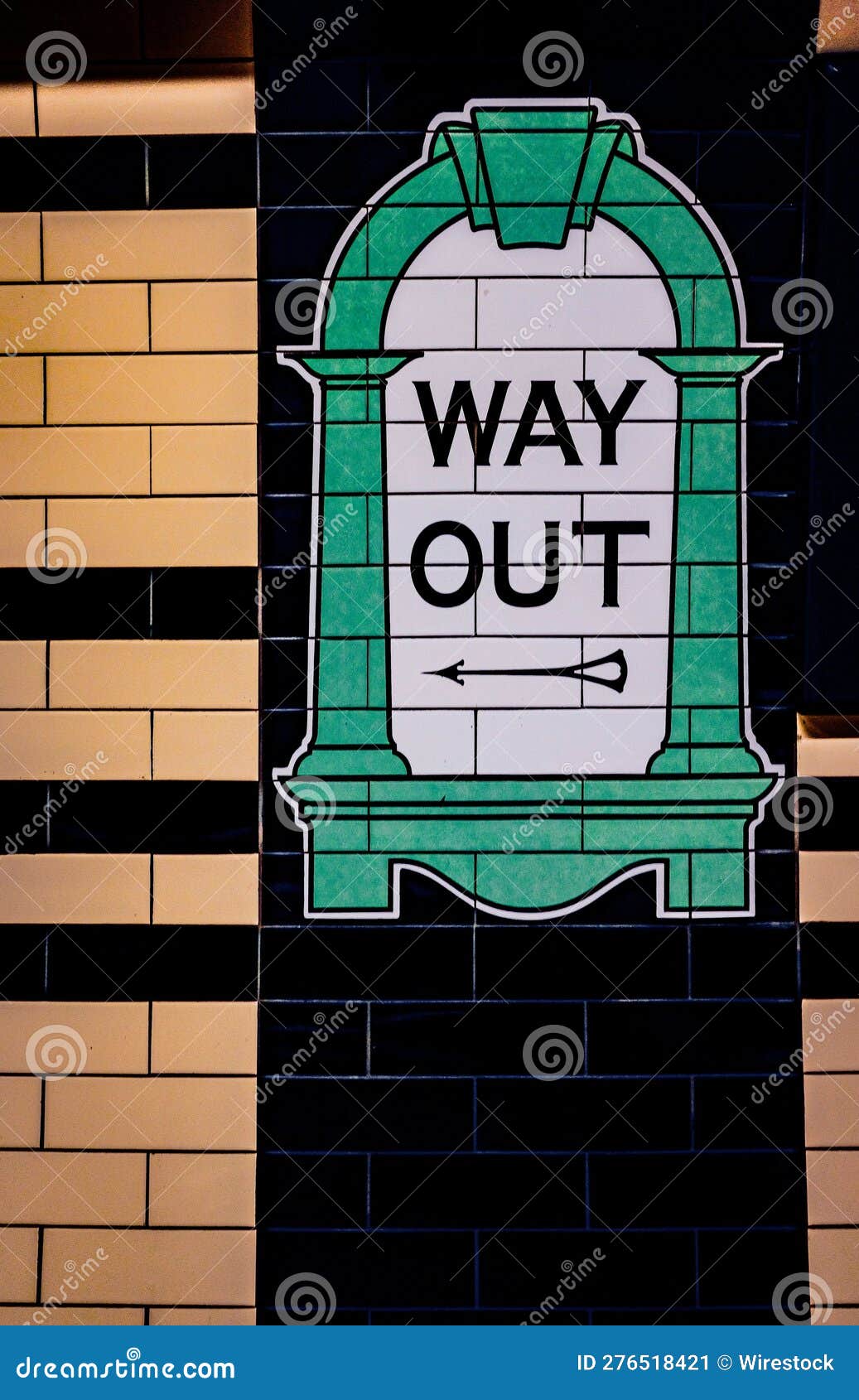 Vertical Rectangular Way Out Sign Against a Brick Wall in a Subway ...