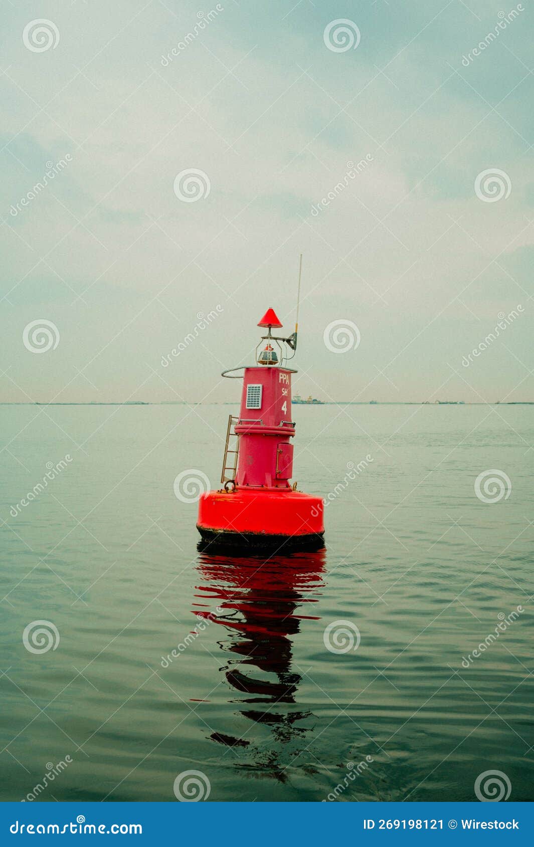 Vertical of a Red Beacon Floating in the Sea with the Sky and the ...