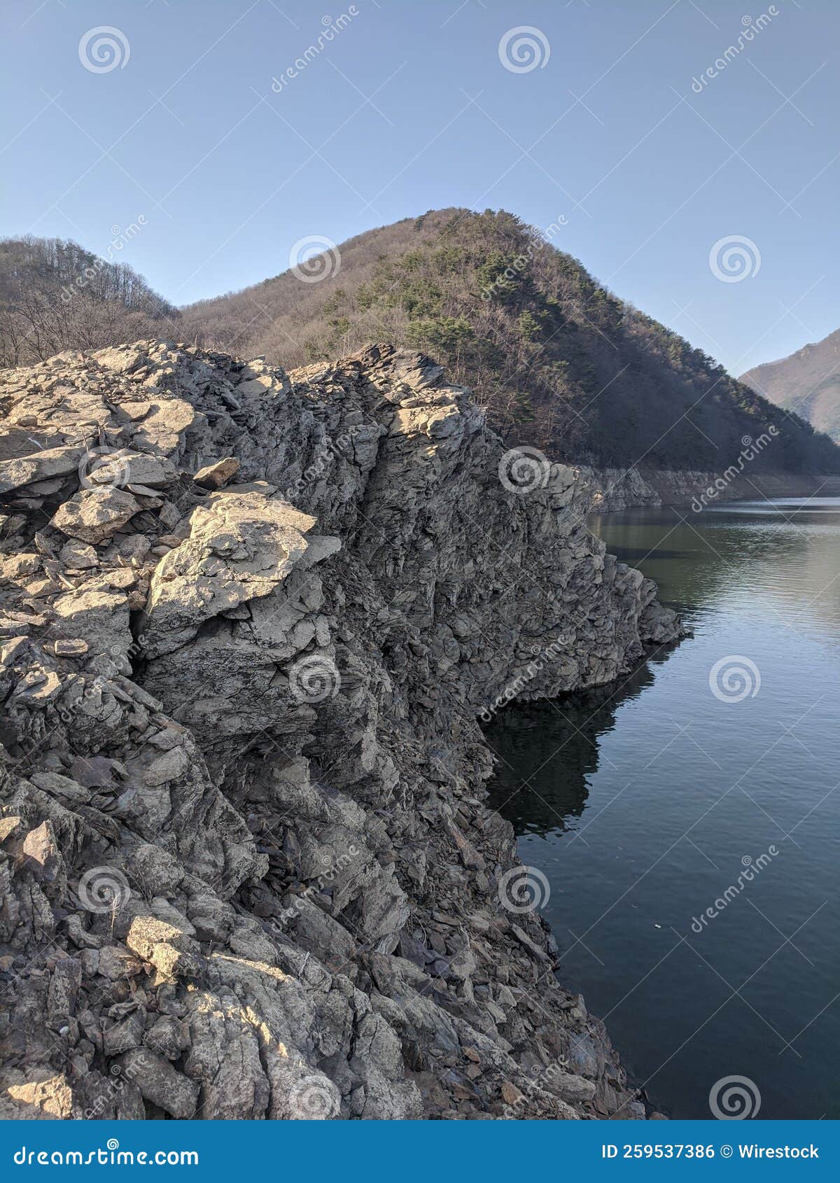 Vertical of a Rock Formation Around the Sea Stock Photo - Image of ...