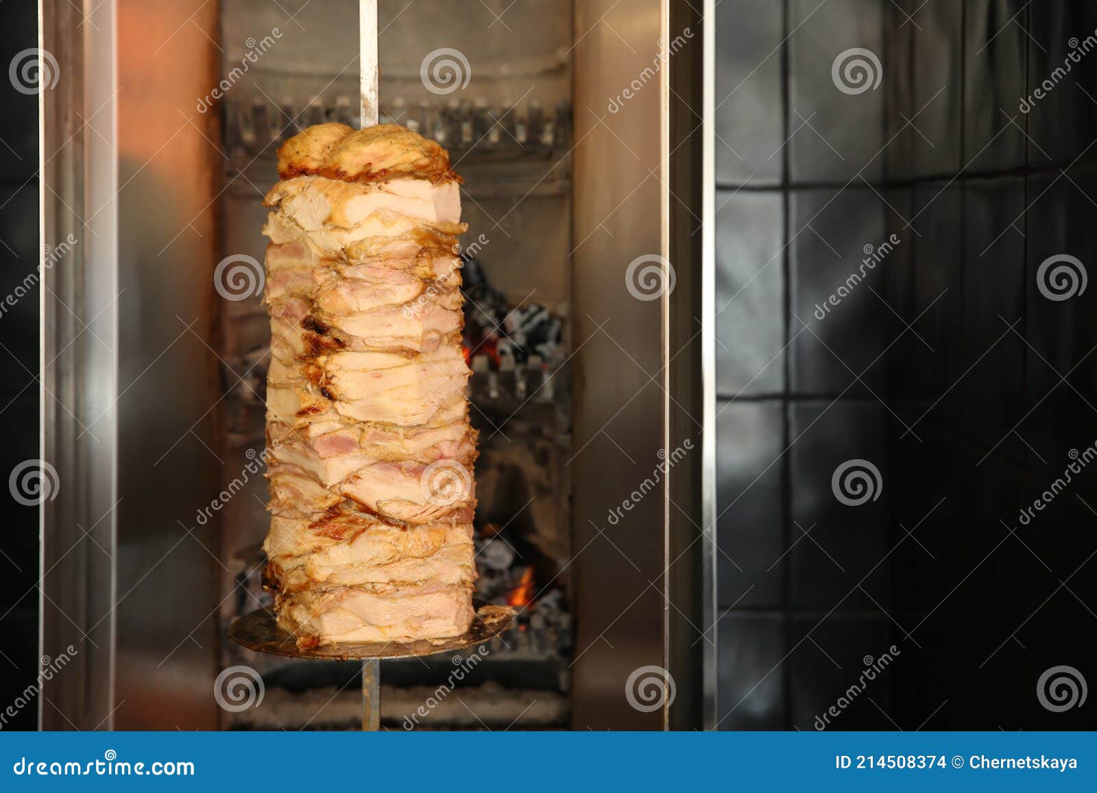 Vertical Rotisserie with Roasted Meat in Restaurant Kitchen. Space for ...