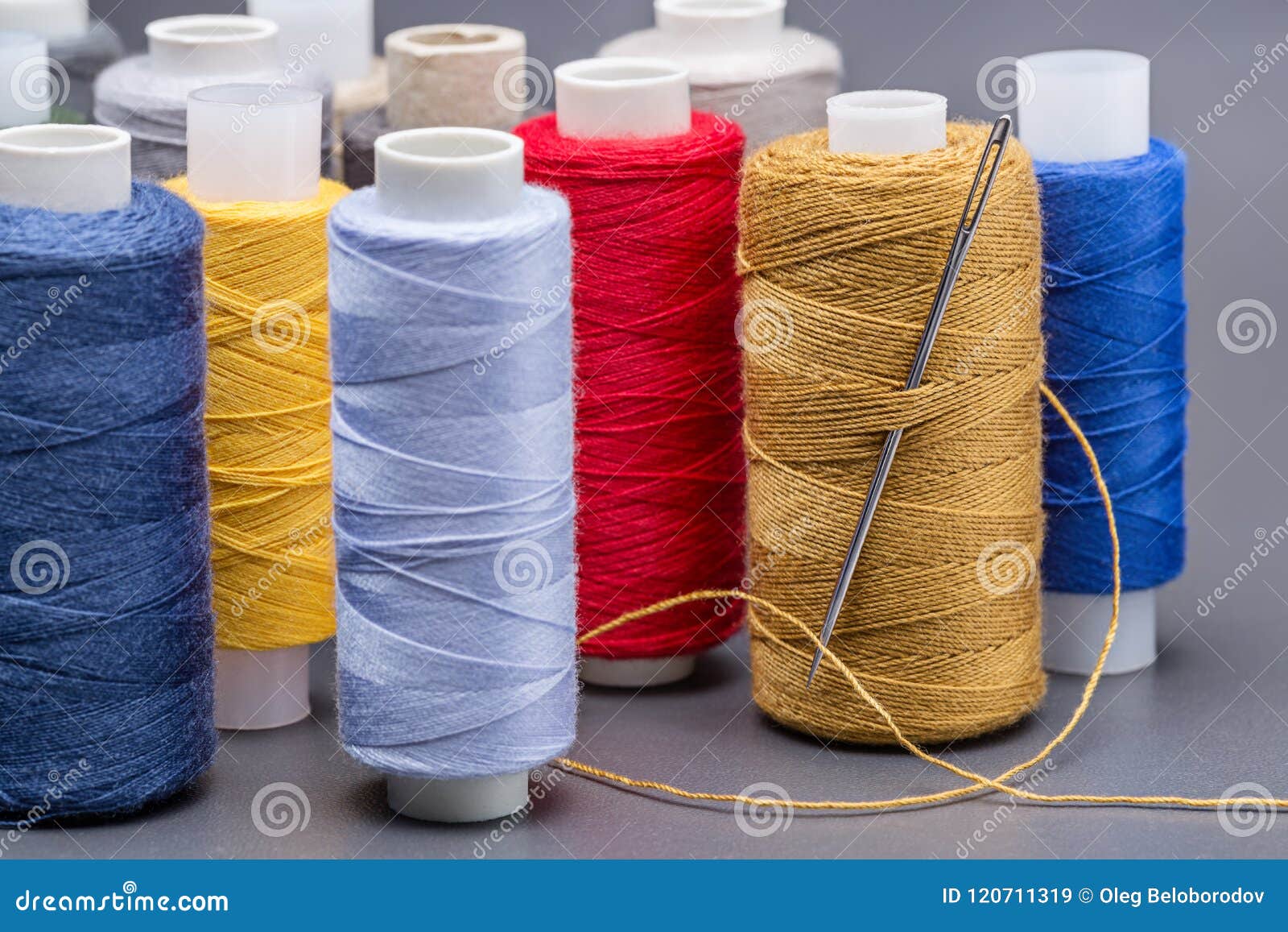 Vertical Row of Coils with Bright Colored Threads, Large Needle and ...