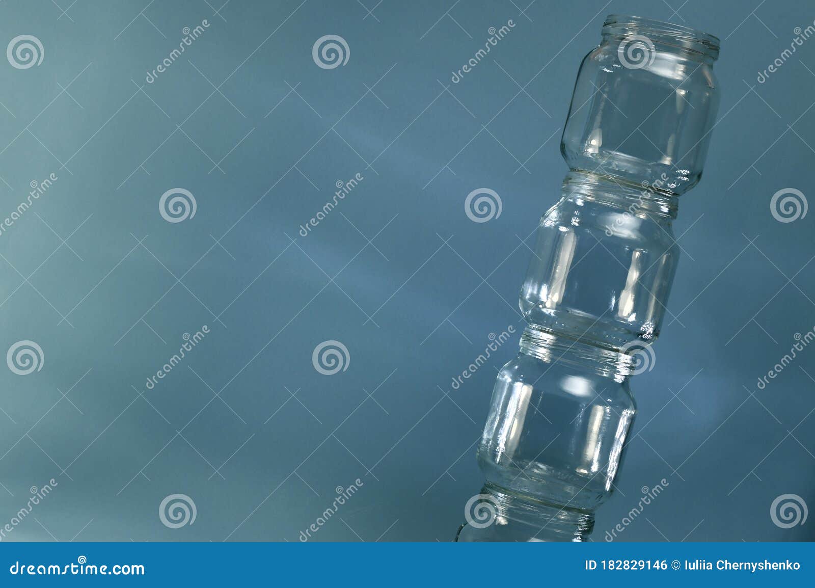 Vertical Row of Falling Glass Jars on a Blue Background Stock Photo ...