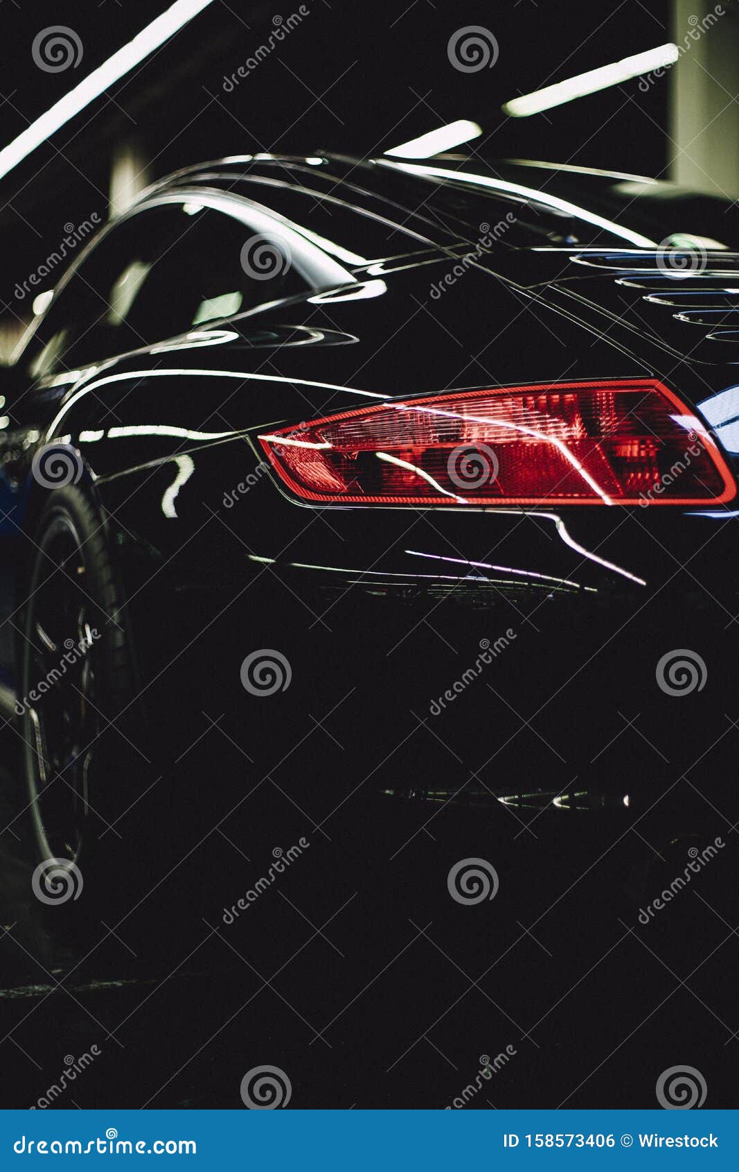 Vertical Selective Shot of the Taillight of a Black Sports Car Stock ...