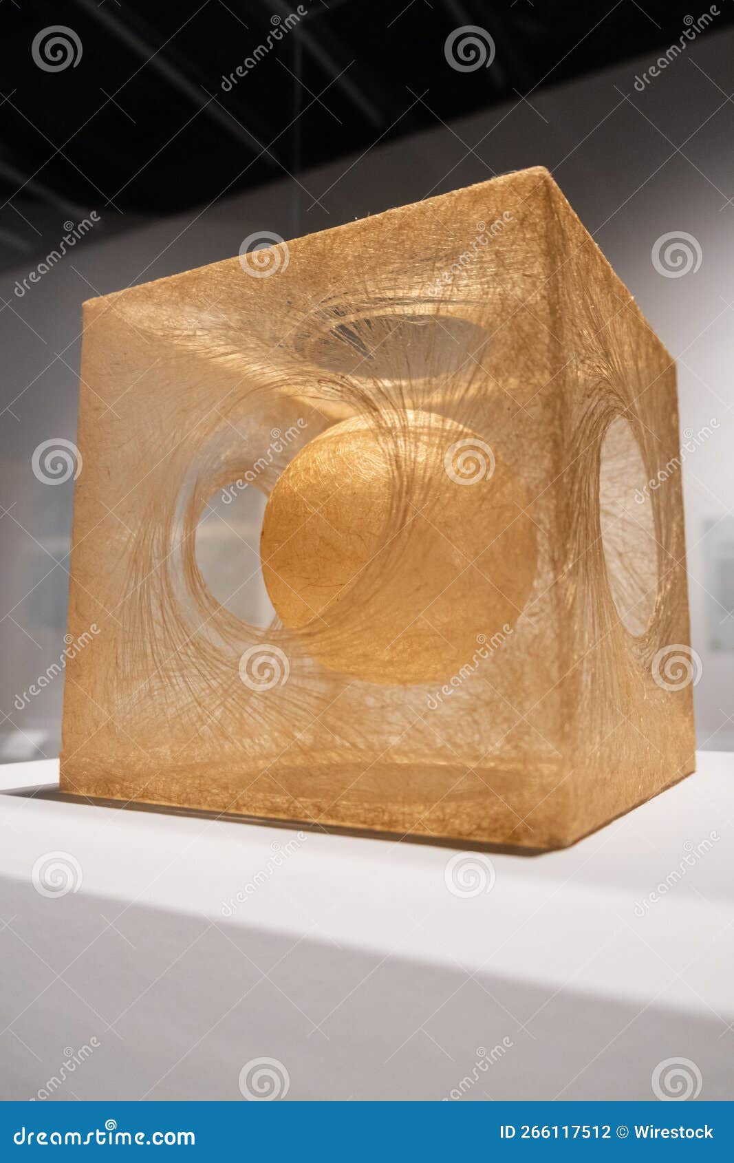 Vertical Shot of an Art-object of a Cube with a Ball in it at the Mint ...