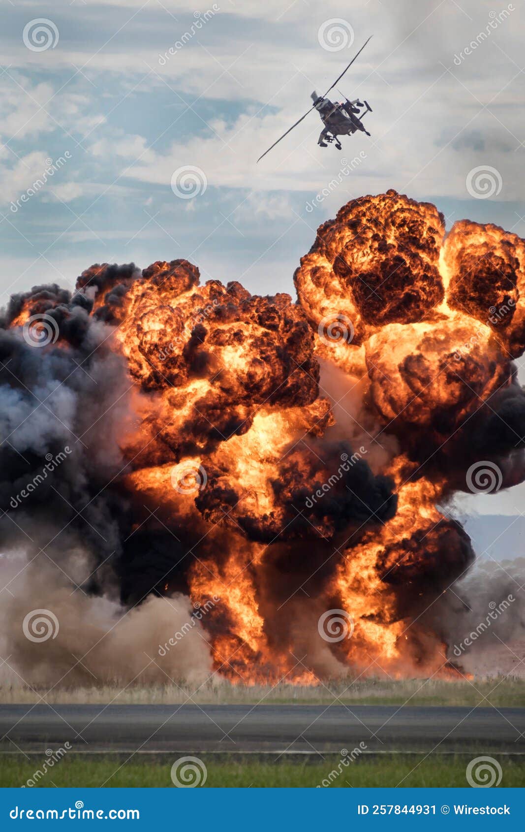 Vertical Shot of an Attack Helicopter Flying Over an Explosion Stock ...