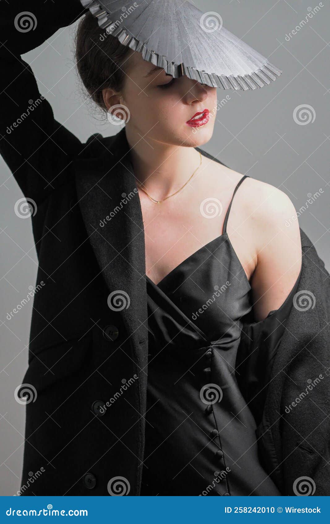Vertical Shot of an Attractive Female Posing with a Fan Stock Photo ...