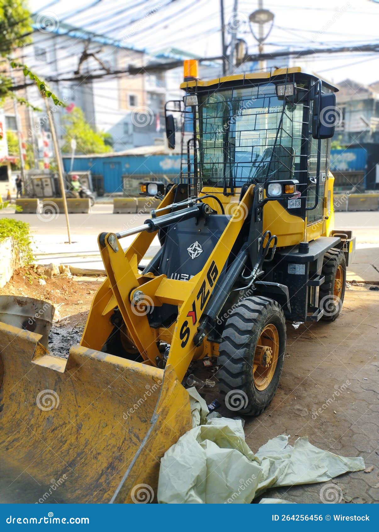 Vertical Shot of a Backhoe Loader on the Side of the Street in Jakarta ...