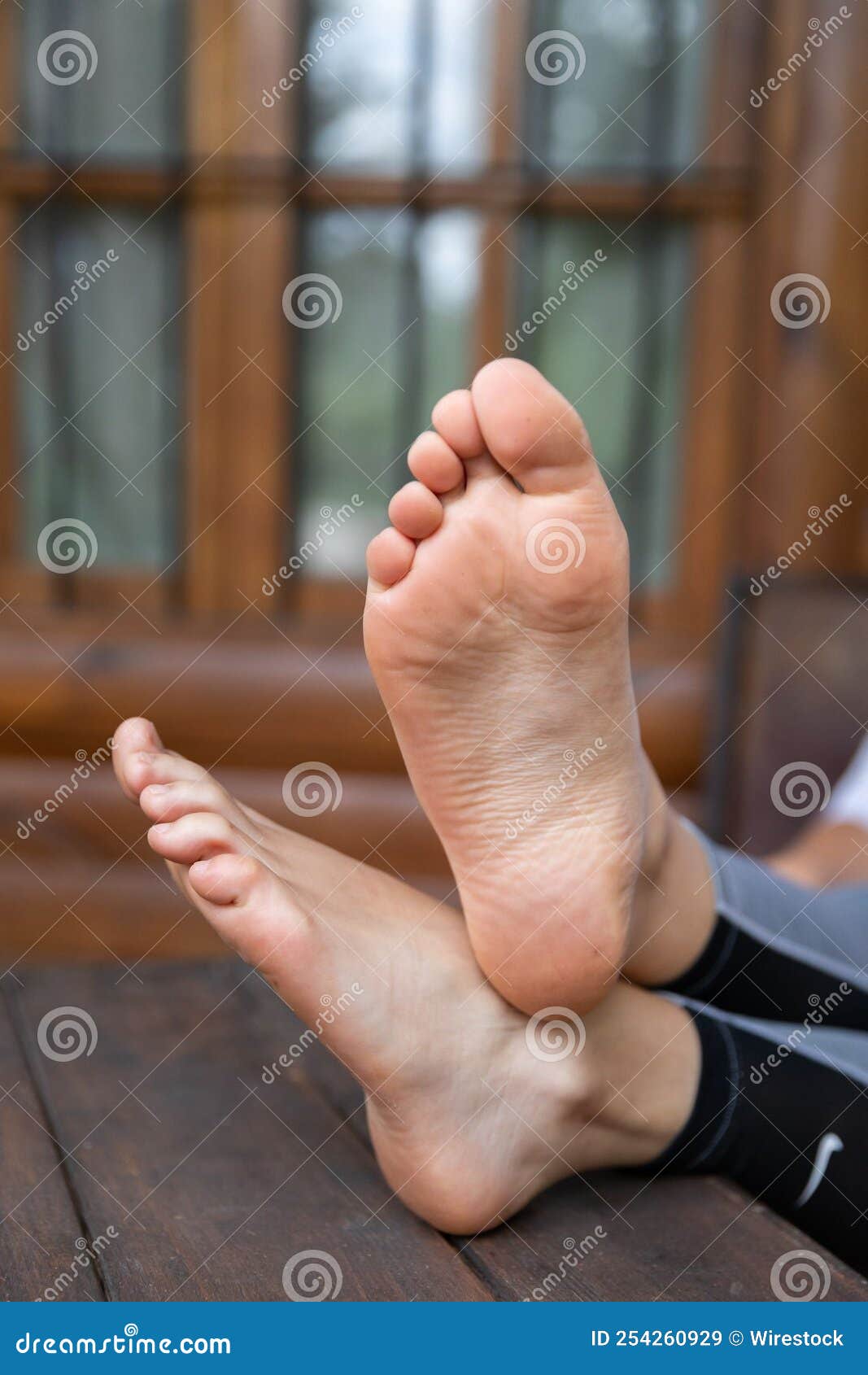 Vertical Shot of Bare Feet Up on a Wooden Table Stock Image - Image of ...