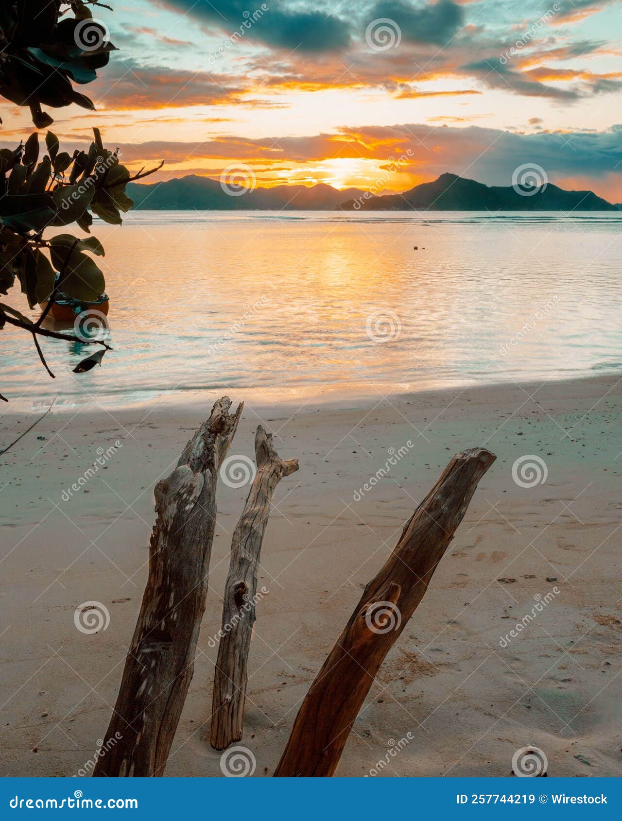 Vertical Shot of a Beach with Mountains in the Background during Sunset ... Vertical Shot of a Beach with Mountains in the Background during Sunset ...