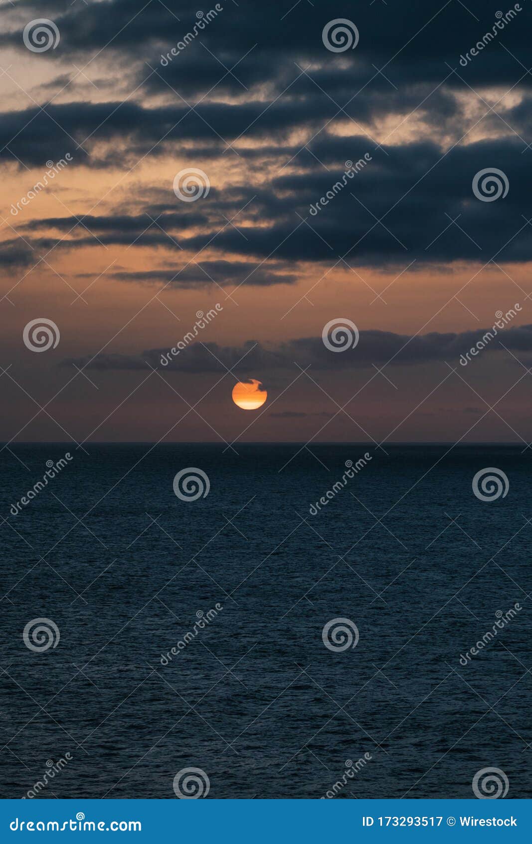 Vertical Shot of a Beautiful Setting Sun Over an Ocean Stock Image ...