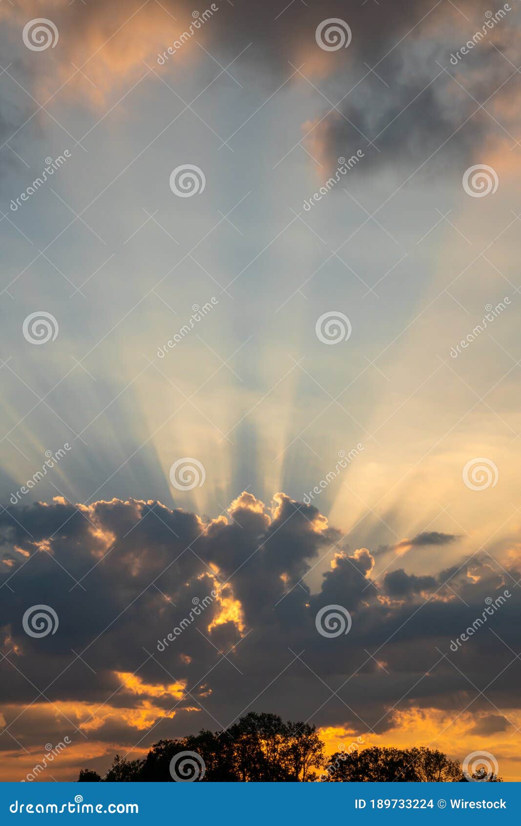 Vertical Shot of Beautiful Sunset with Rays of the Sun Behind the ...
