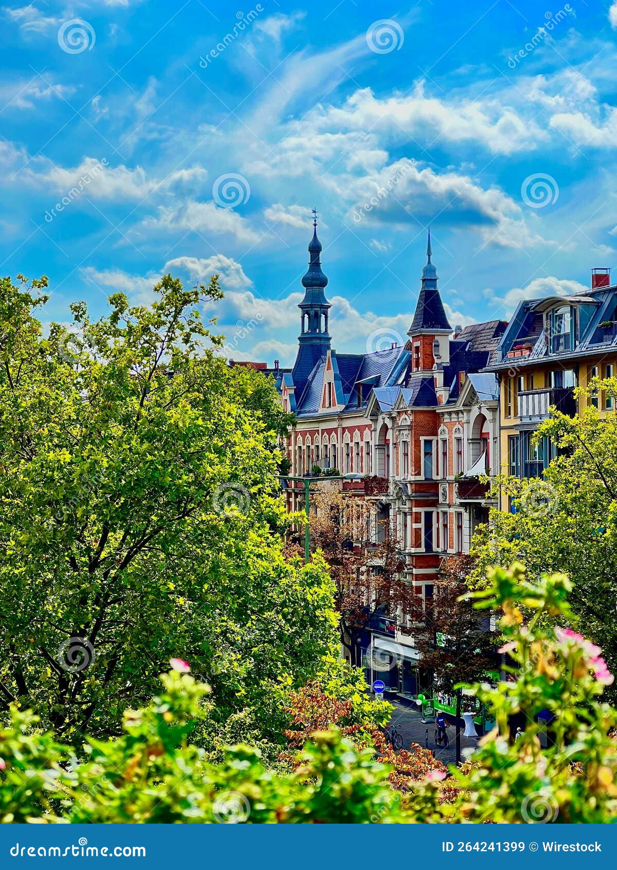 Vertical Shot of Berlin Architectures Behind Trees from a Balcony in ...