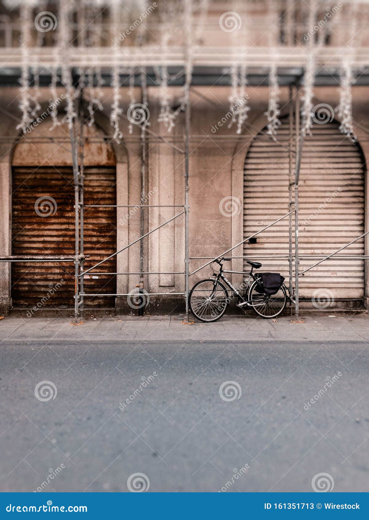 Vertical Shot of a Bicycle Parked on the Street in Front of Arch Doors ...
