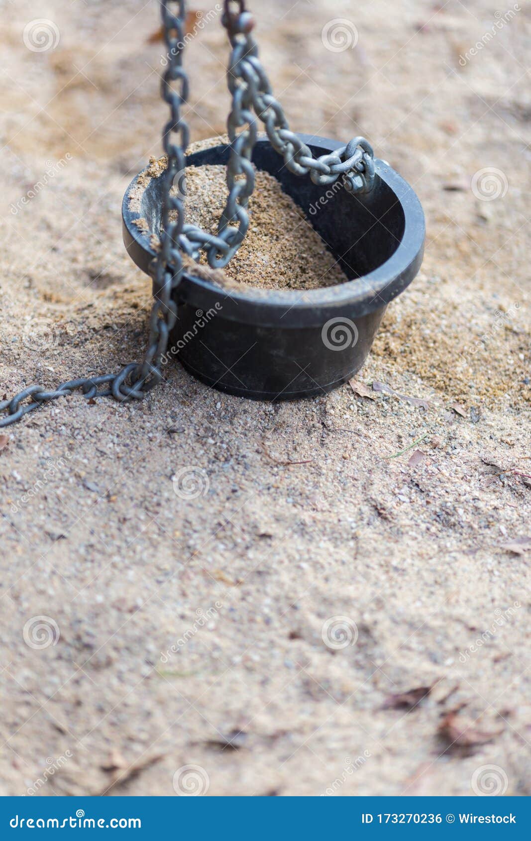 Vertical Shot of a Black Container Tied To Chains with Sand Inside ...