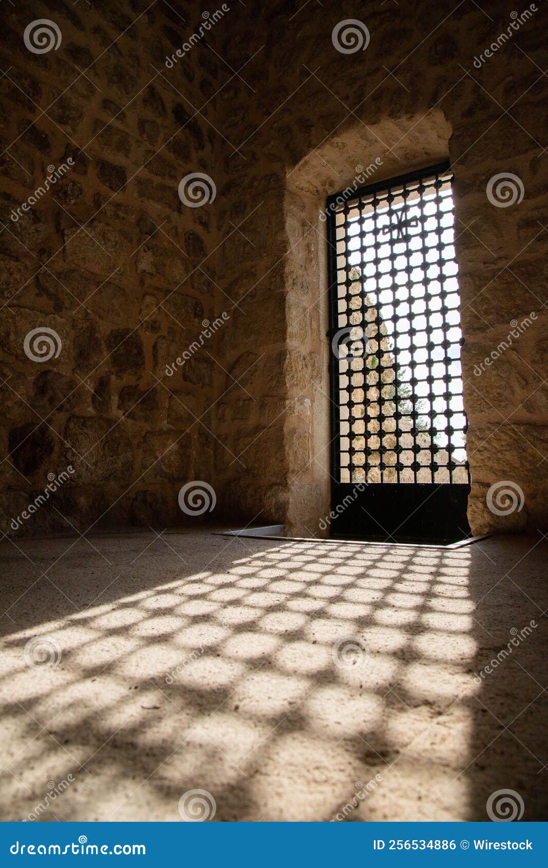 Vertical Shot of a Black Gate with Shadow on the Ground Stock Photo ...