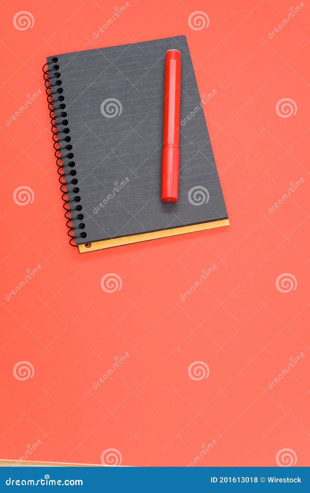 Vertical Shot of a Black Notebook and a Red Marker on a Red Surface ...