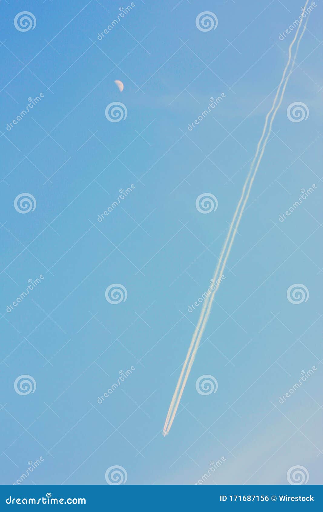 Vertical Shot of the Blue Beautiful Sky with Airplane Engine Trails and ...