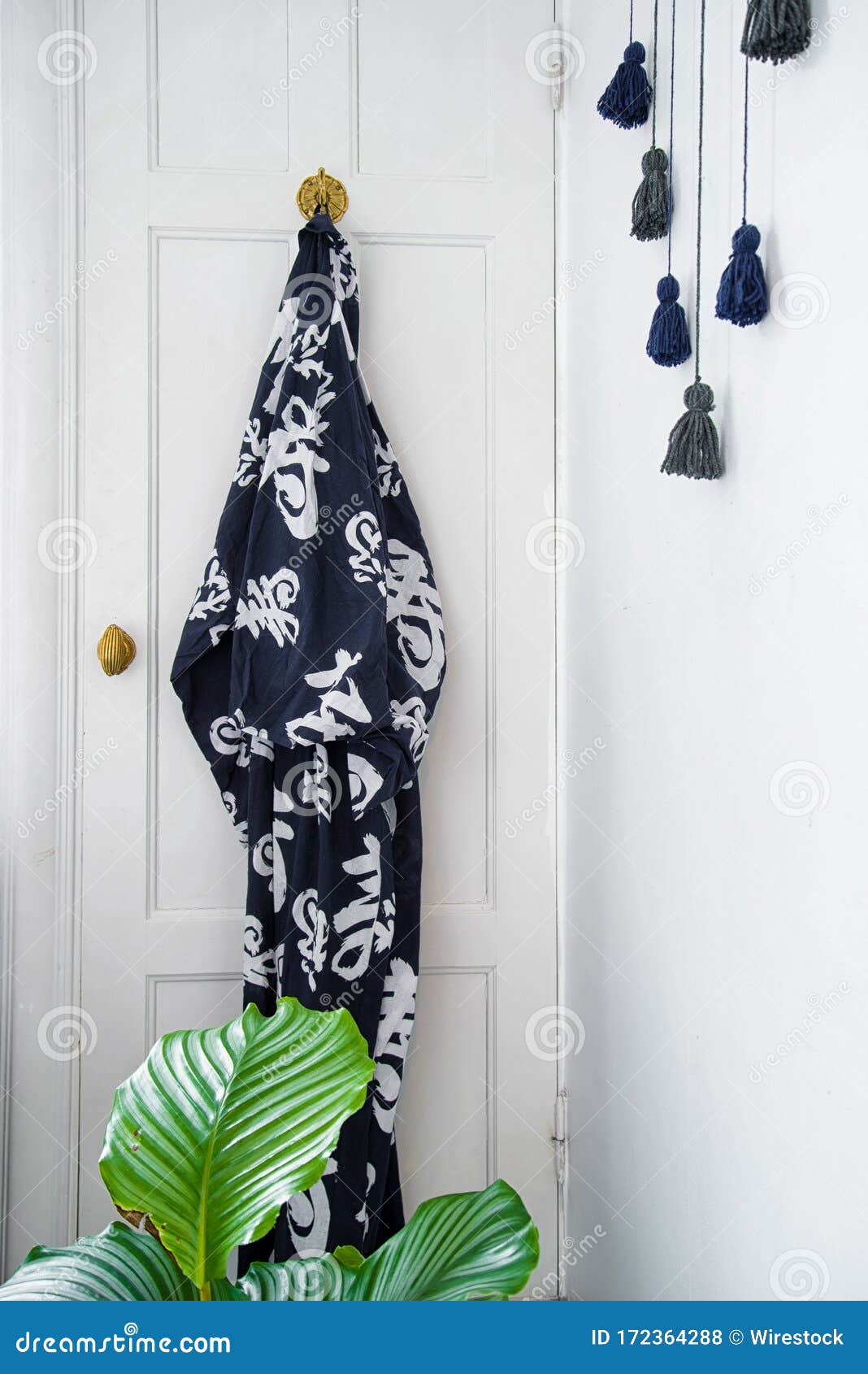 Vertical Shot of a Blue Robe Hanging on a White Bathroom Door Stock ...