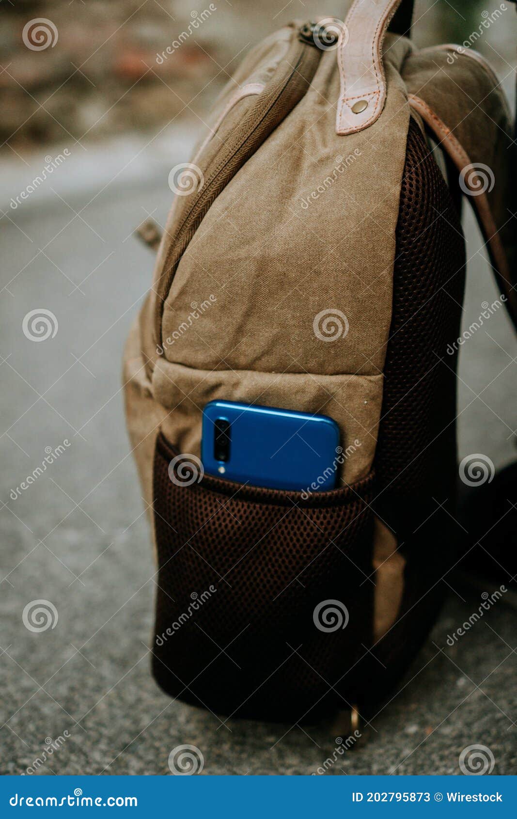 Vertical Shot of a Blue Smartphone in the Side Pocket of a Backpack on ...