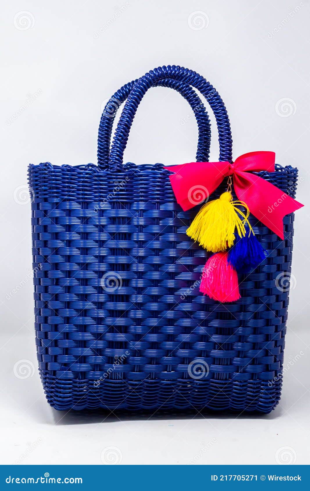 Vertical Shot of a Blue Wicker Bag with Colorful Patterns Isolated on a ...