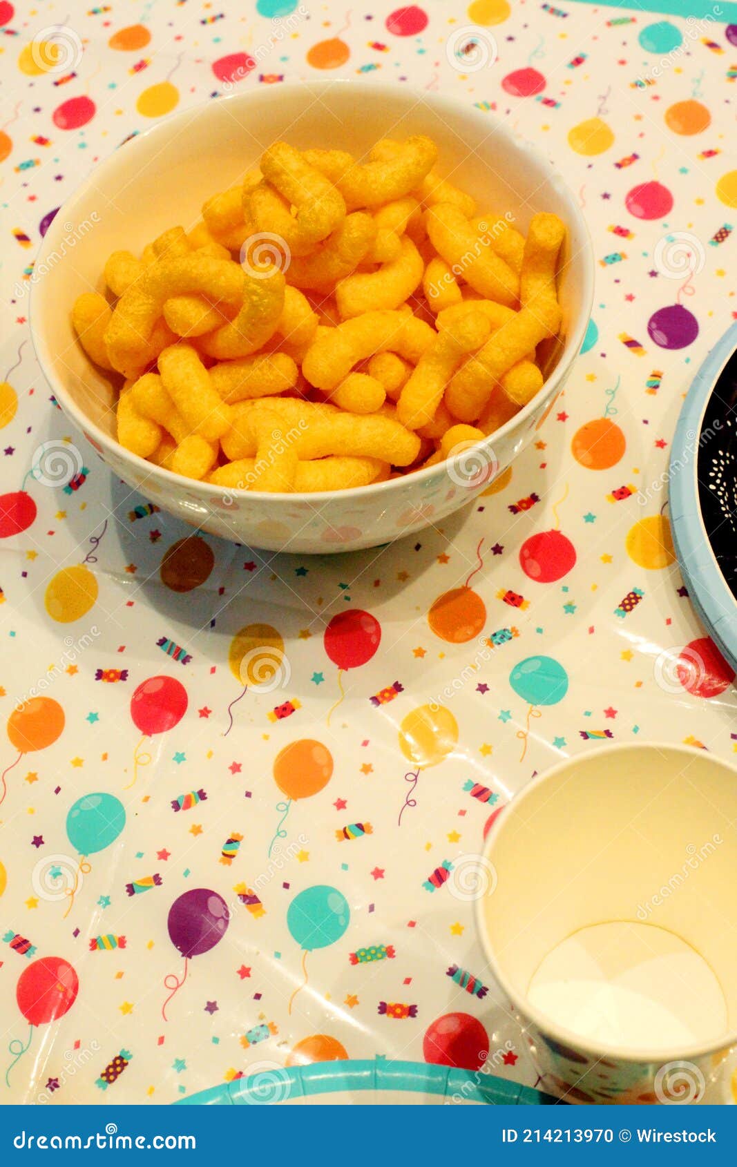 Vertical Shot of a Bowl of Cheese Puffs on a Table Stock Photo - Image ...