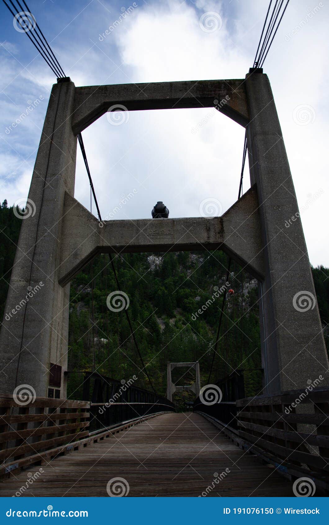 Vertical Shot of a Bridge Connecting Two Sides on a Hill Covered with ...