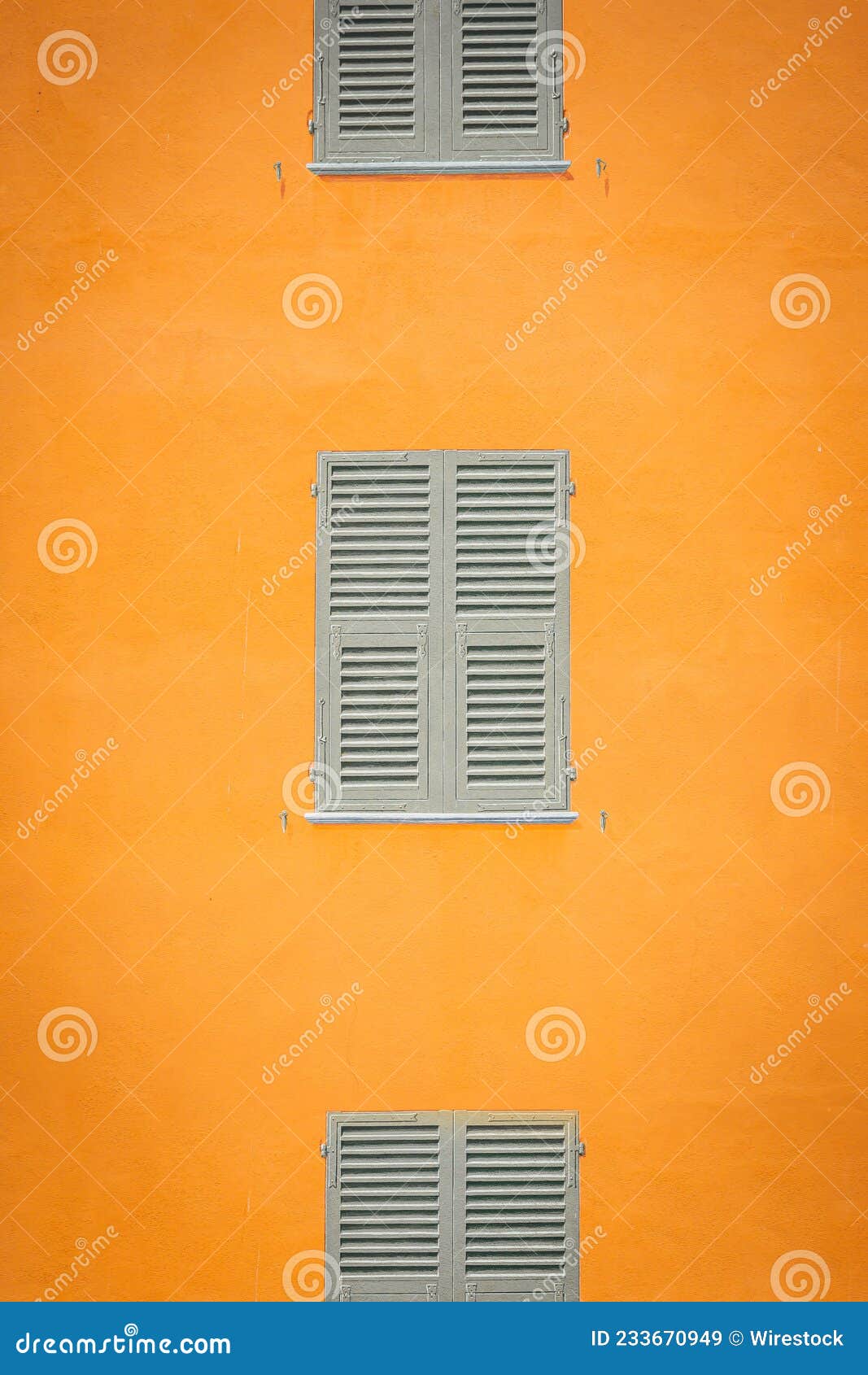 Vertical Shot of the Bright Orange Building Wall with Windows. Stock ...
