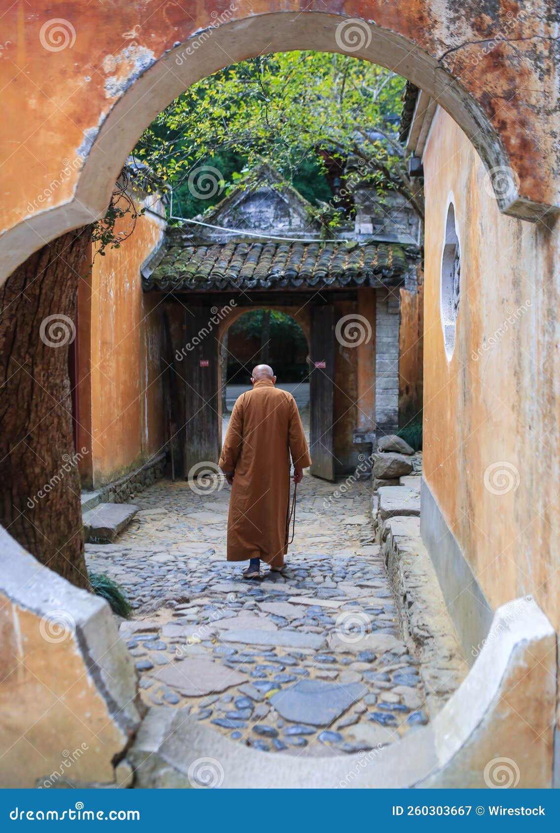 Vertical Shot of a Buddhist Monk Walking Out of the Temple Stock Image ...