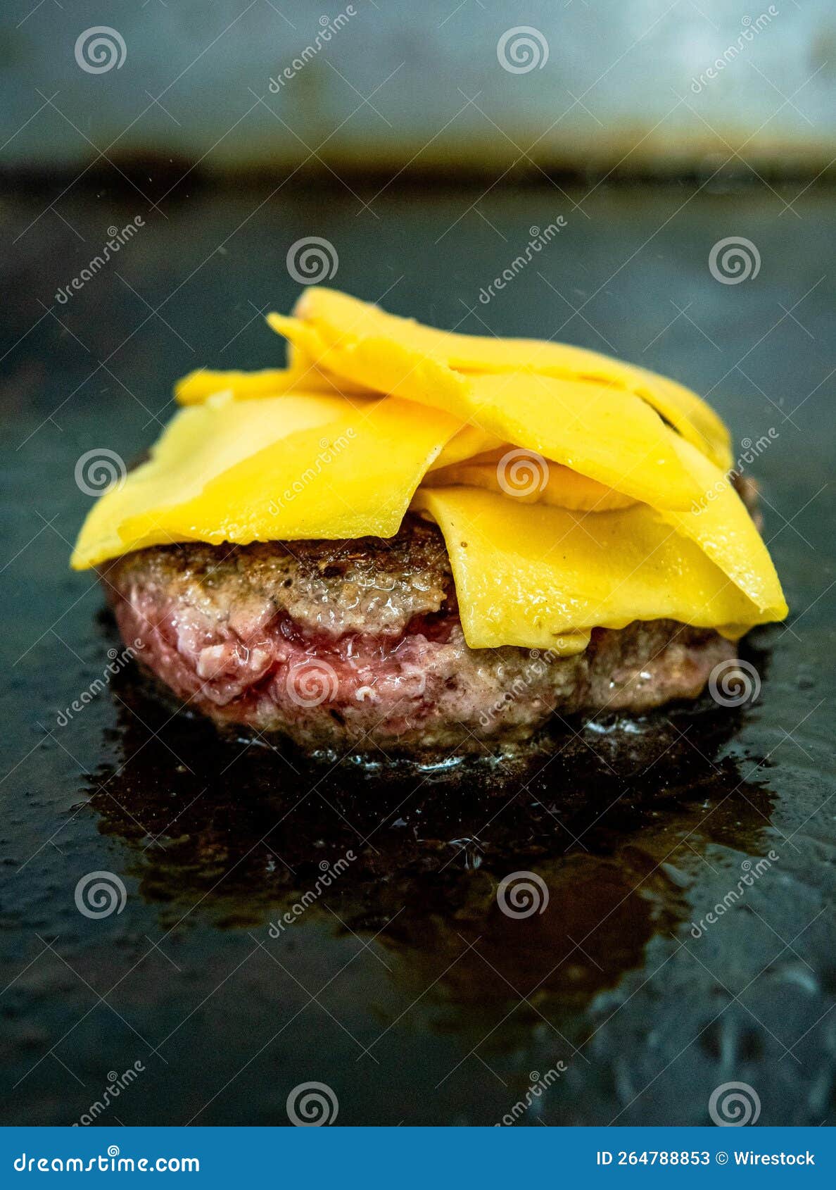 Vertical Shot of Burger with Cheese Slices on the Grill Stock Image ...