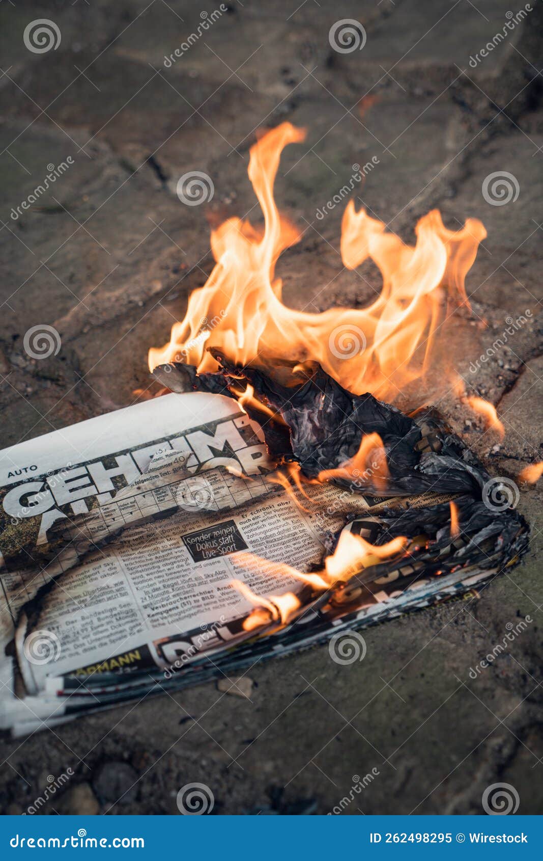 Vertical Shot of a Burning BILD Zeitung Newspaper on the Ground ...